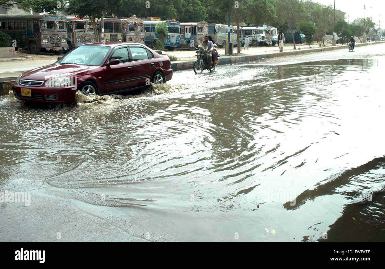 Vehicles passing through stagnant sewerage water on road which is ...