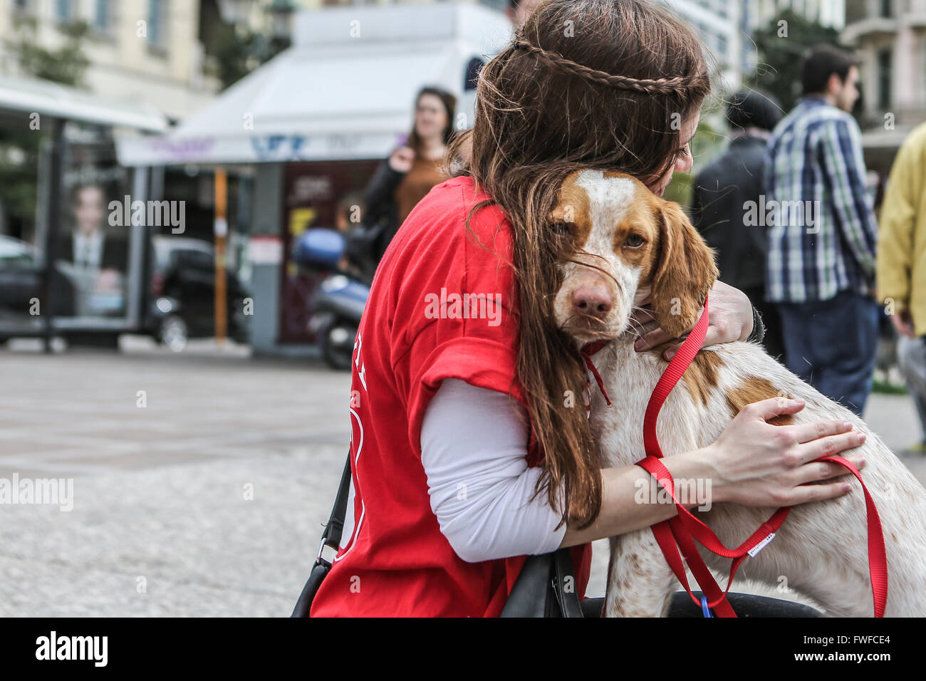 Athens, Greece. 3rd Apr, 2016. A volunteer hugs a stray dog in central ...