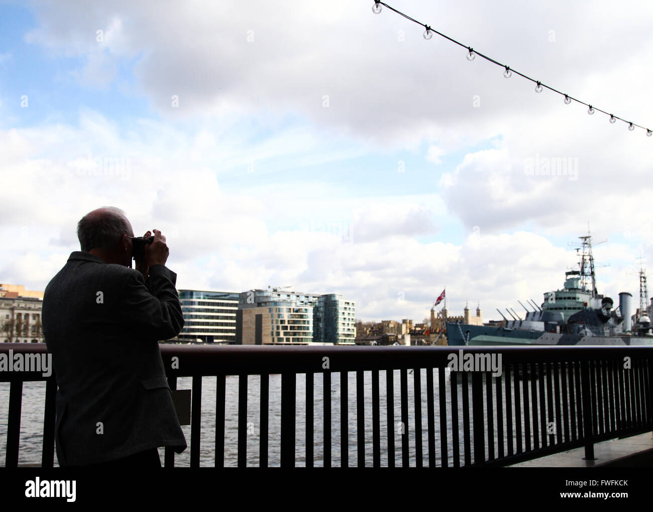 London, UK, 5th April, 2916. A toursit takes a photograph of Tower ...