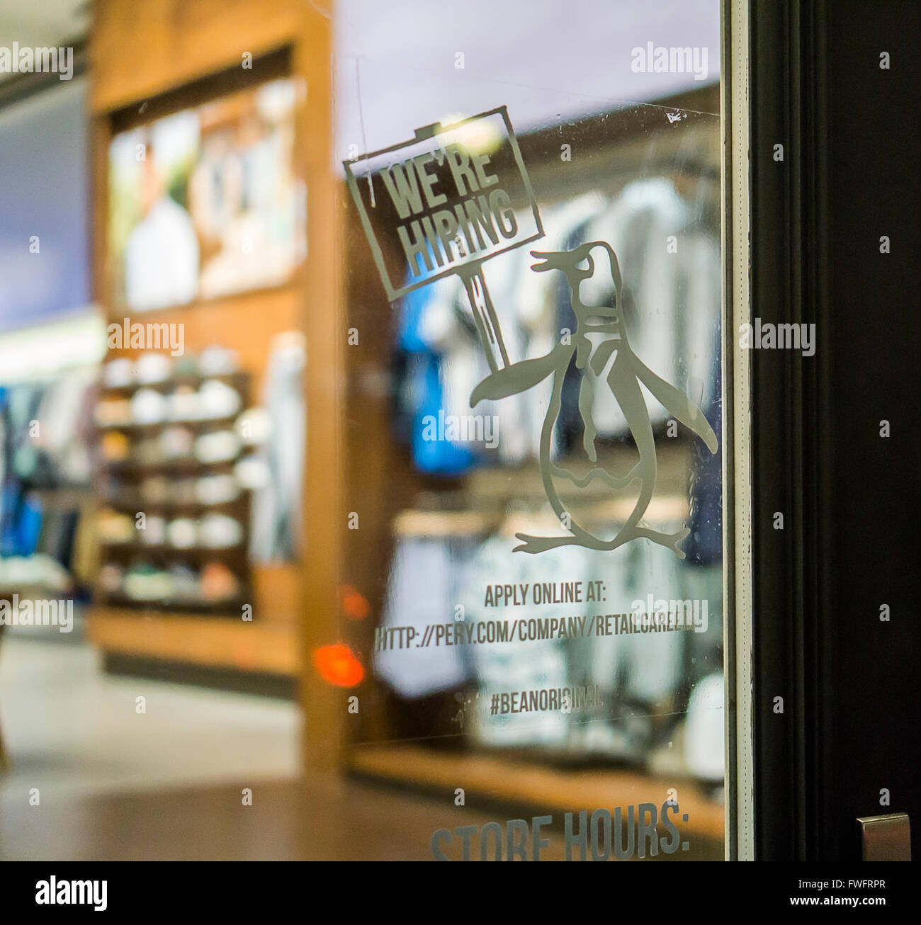 A sign in the window of a branch of an Original Penguin store in New ...