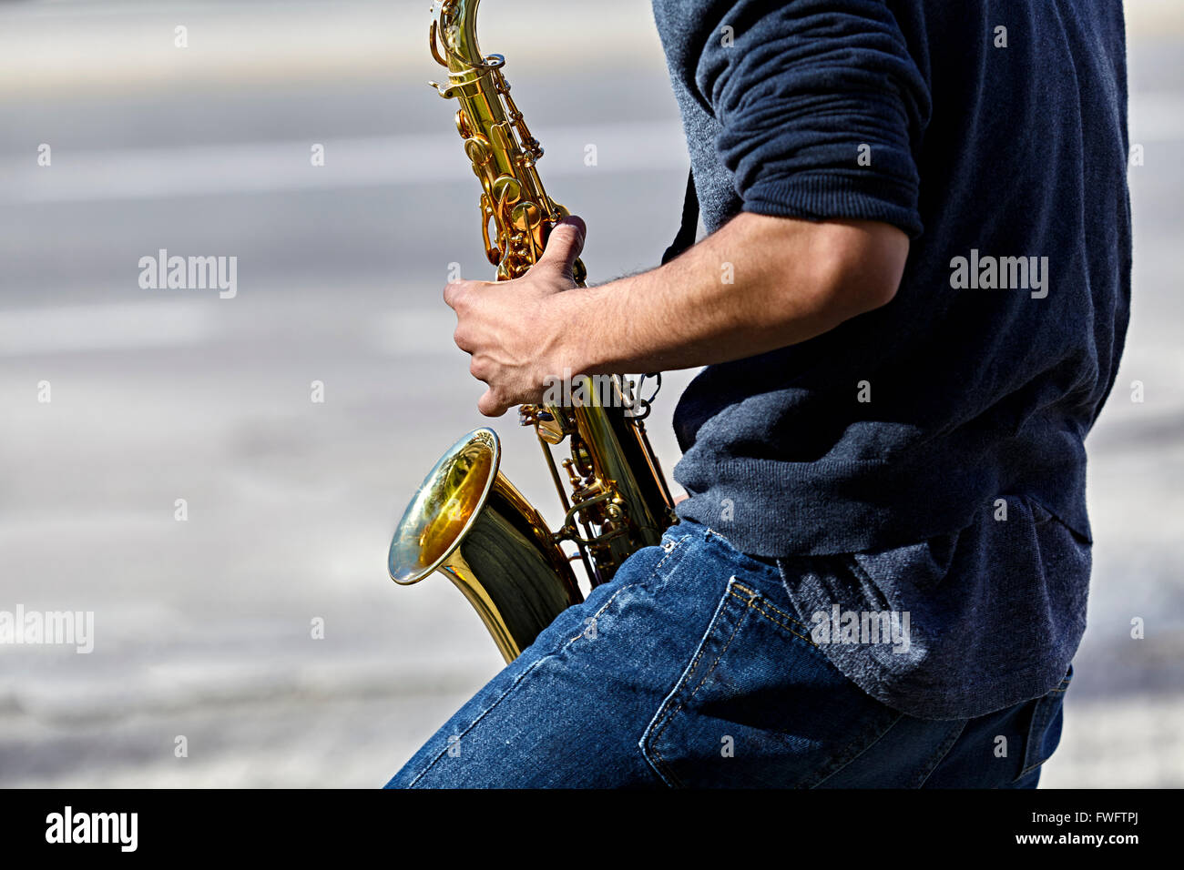 Young adult man playing a saxophone Stock Photo - Alamy