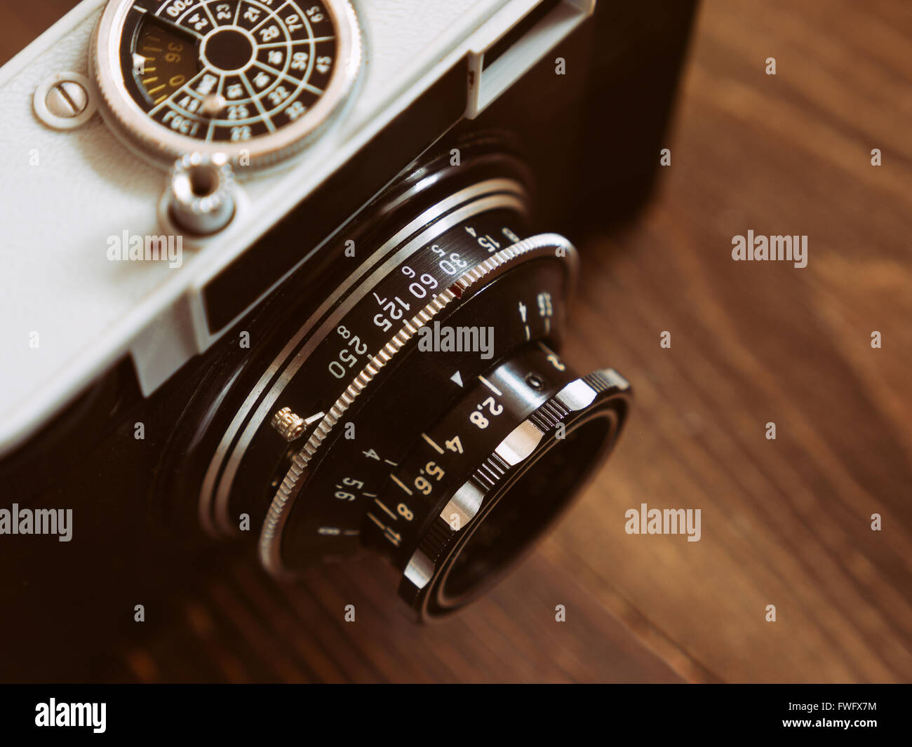 close up photo of old vintage camera lens over wooden table. selective ...