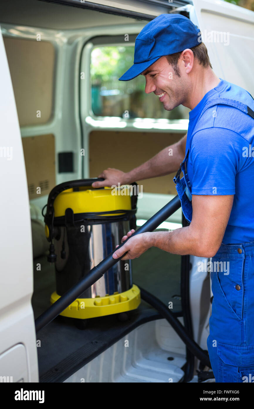 Happy janitor cleaning the car Stock Photo - Alamy
