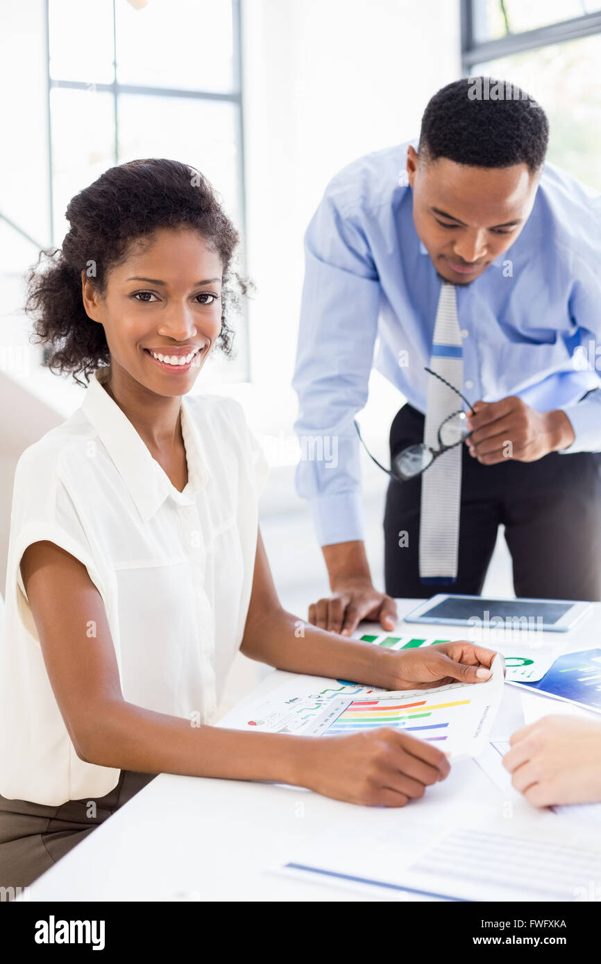Businesspeople looking at reports in meeting Stock Photo - Alamy