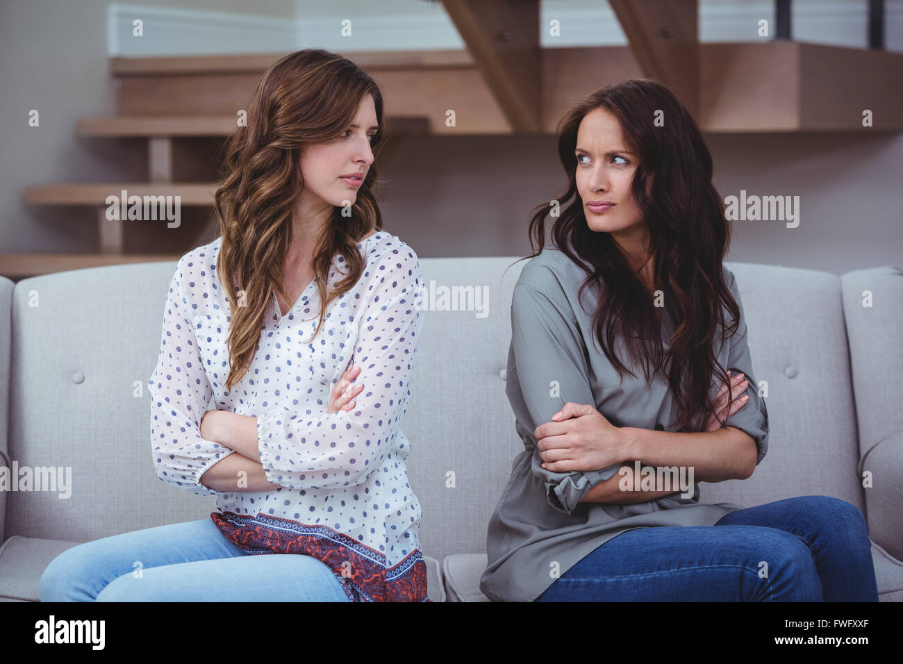 Woman ignoring her friend after an argument Stock Photo - Alamy