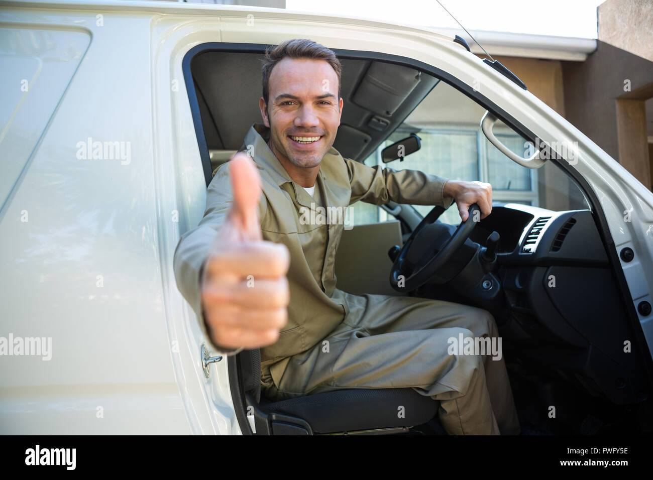 Delivery man sitting in his van Stock Photo - Alamy