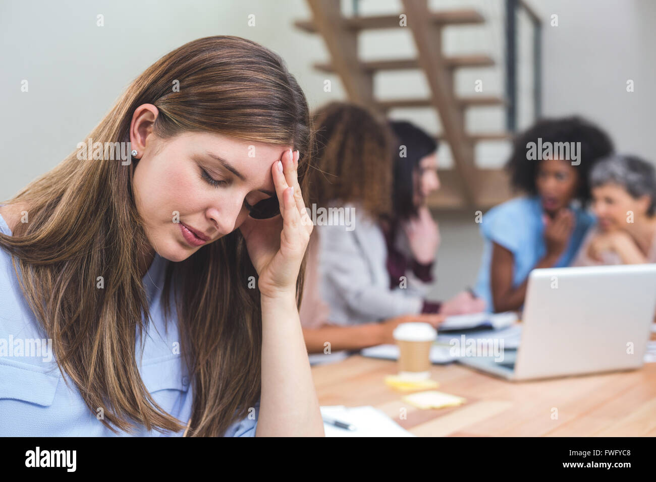 Tense businesswoman sitting in office Stock Photo - Alamy