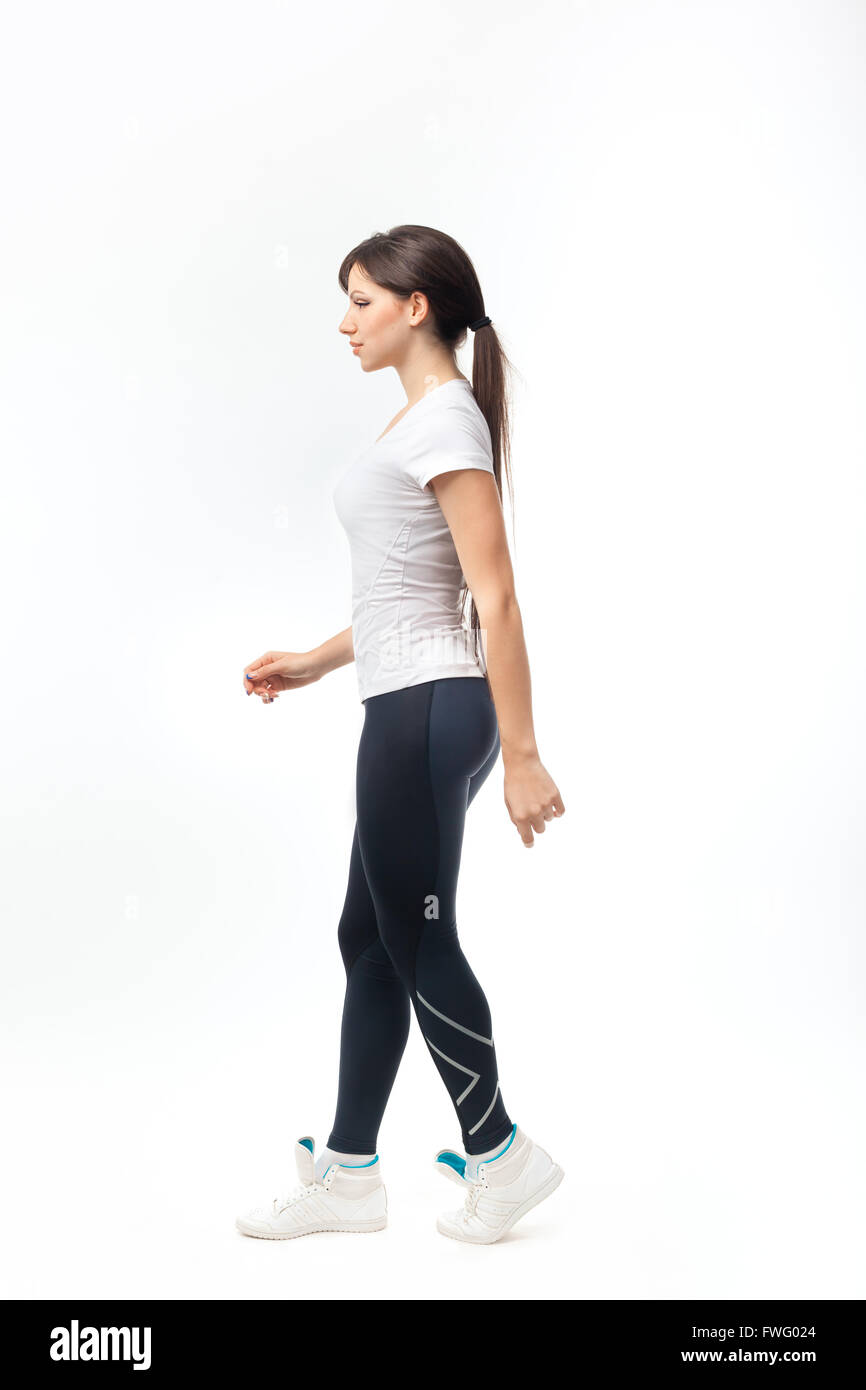 Full length of a young woman walking over white background Stock Photo ...