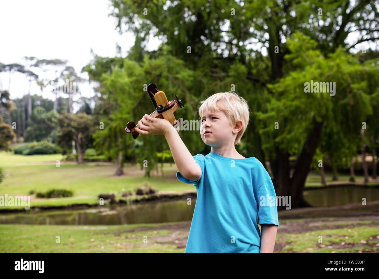 Boy playing with a toy aeroplane Stock Photo - Alamy