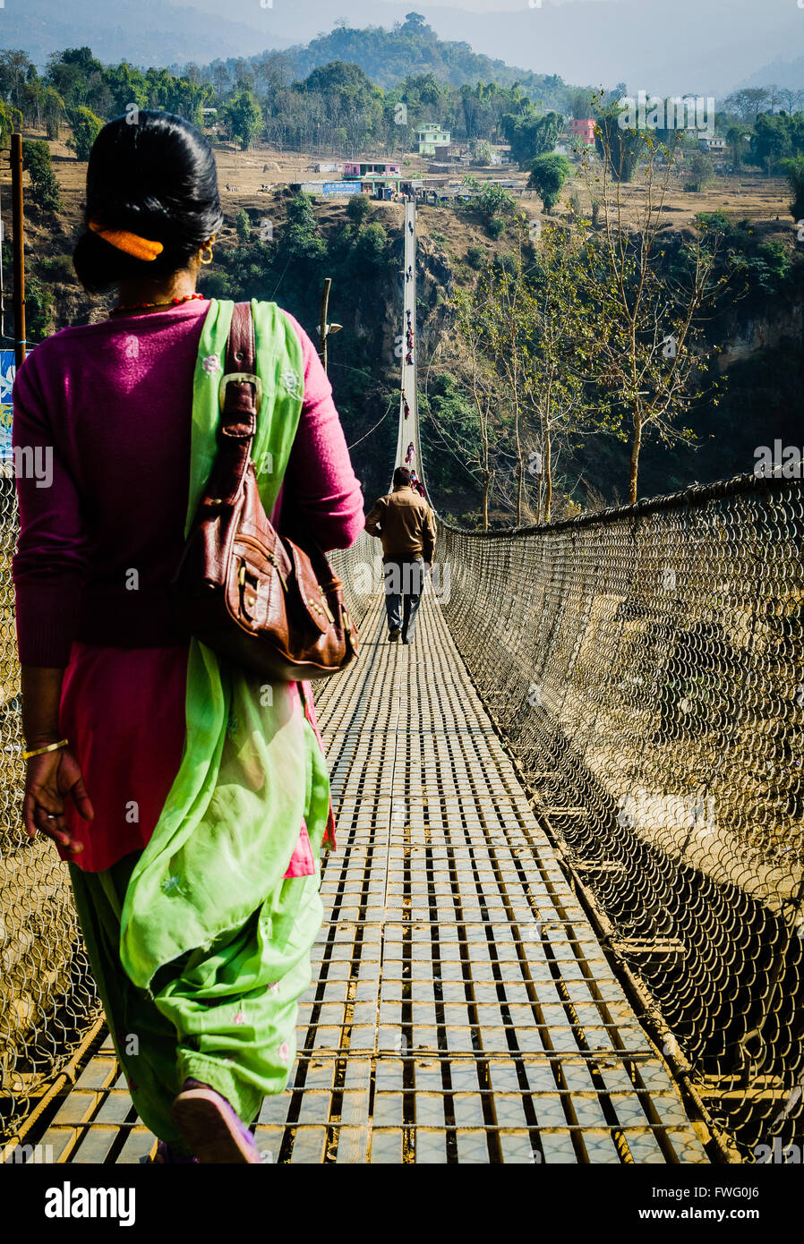 People crossing a trail (suspension) Bridge in Parbat, Nepal Stock ...