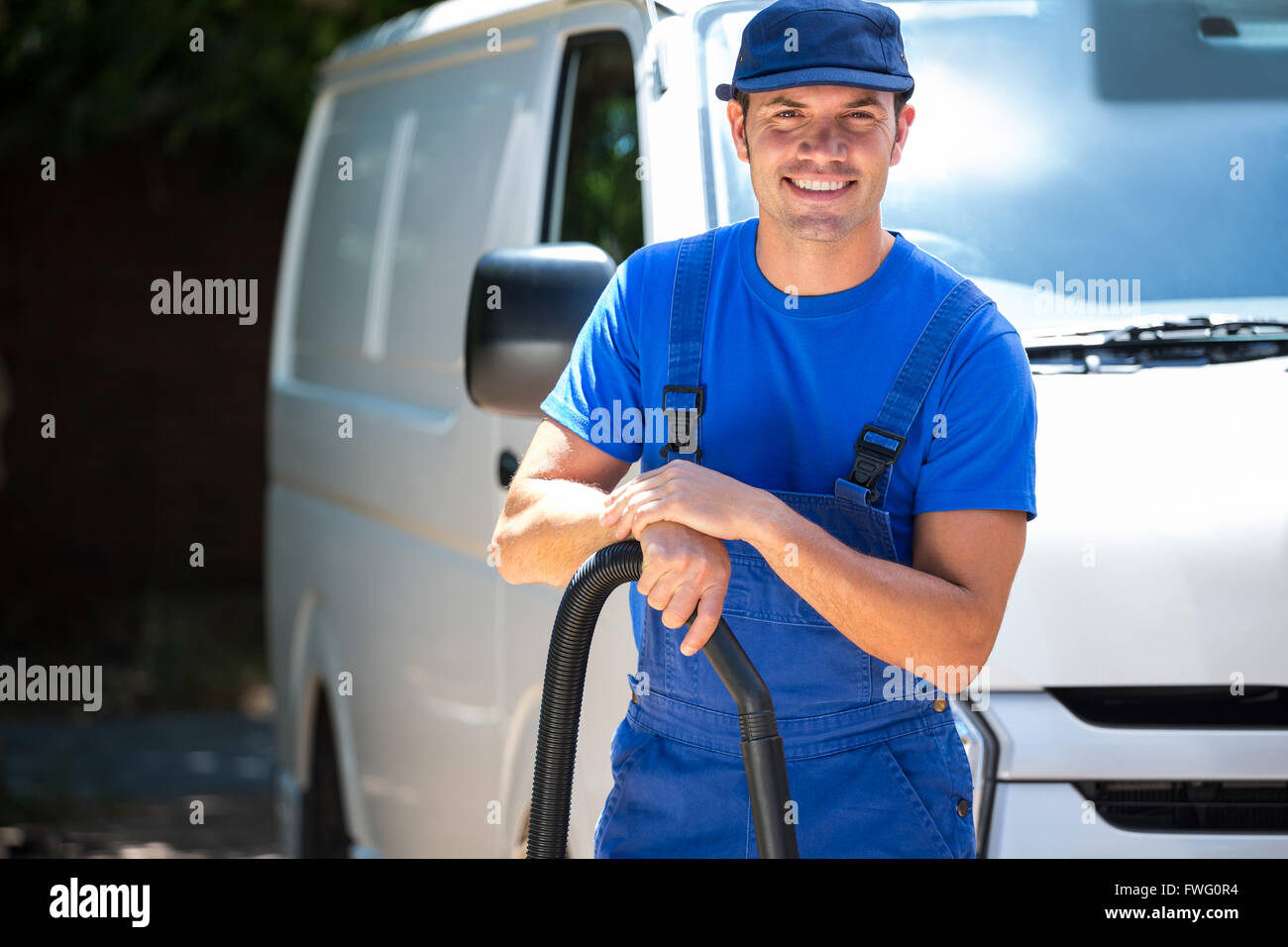 Happy janitor cleaning the car Stock Photo - Alamy