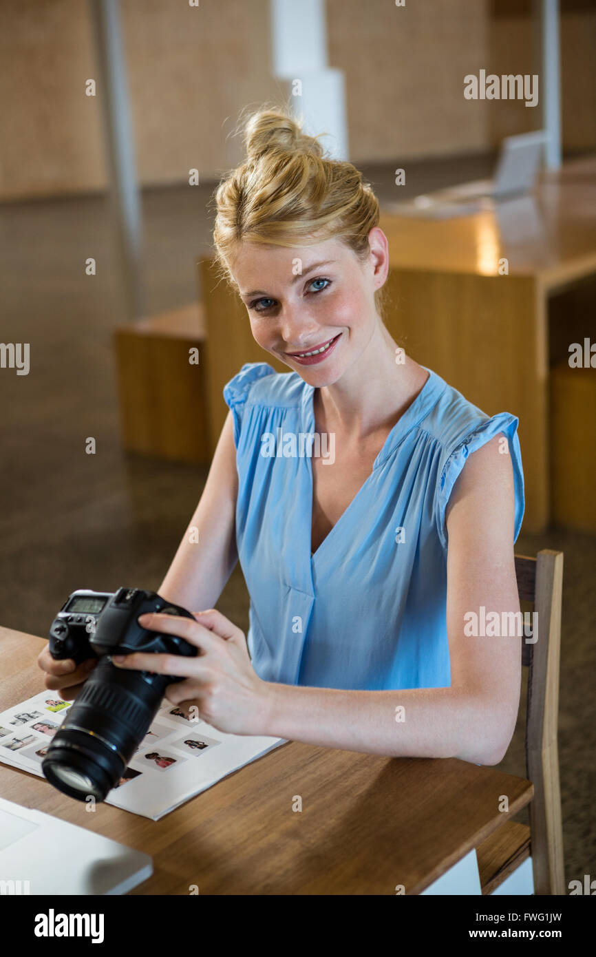 Woman checking photo in camera Stock Photo - Alamy