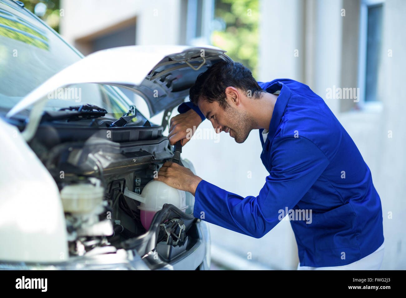 Side view of technician repairing van Stock Photo - Alamy