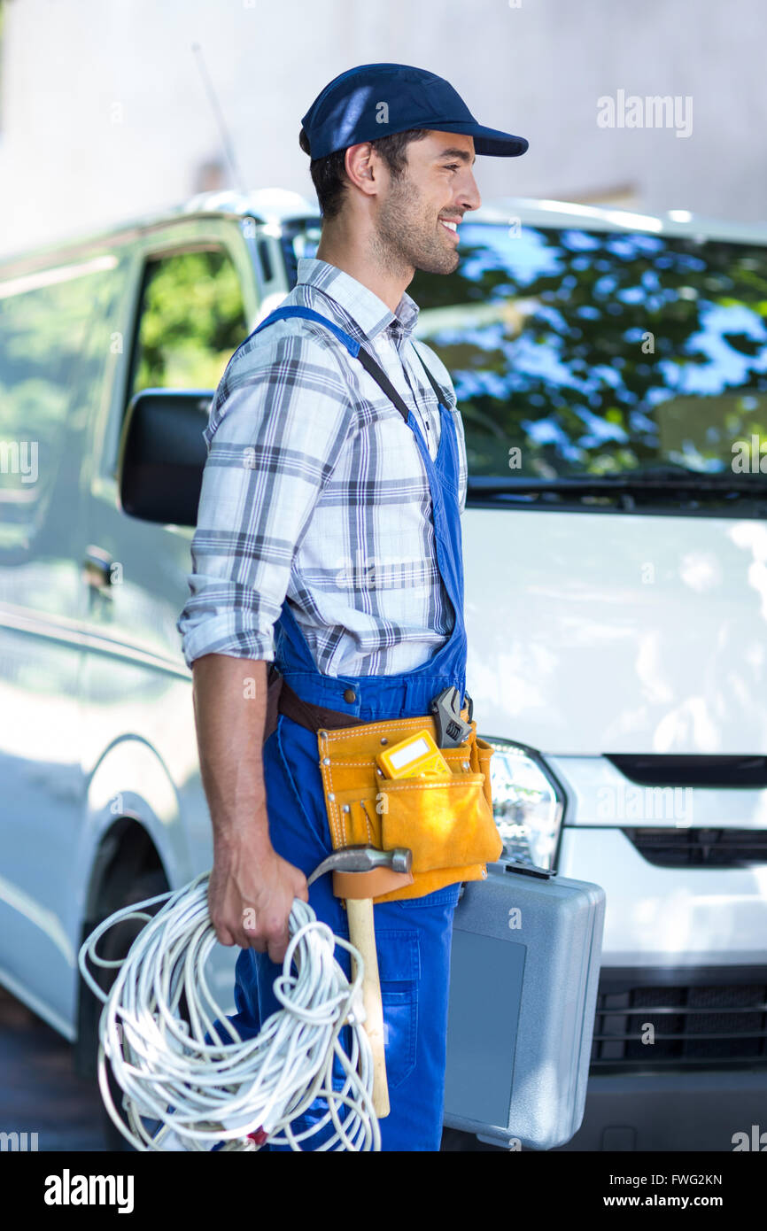 Side view of happy carpenter with toolbox Stock Photo - Alamy