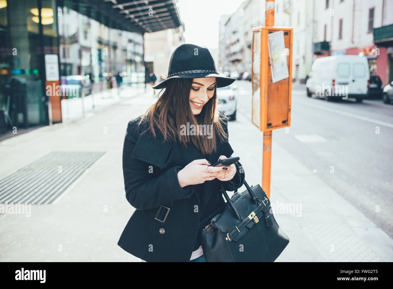Woman standing bus stop hi-res stock photography and images - Alamy