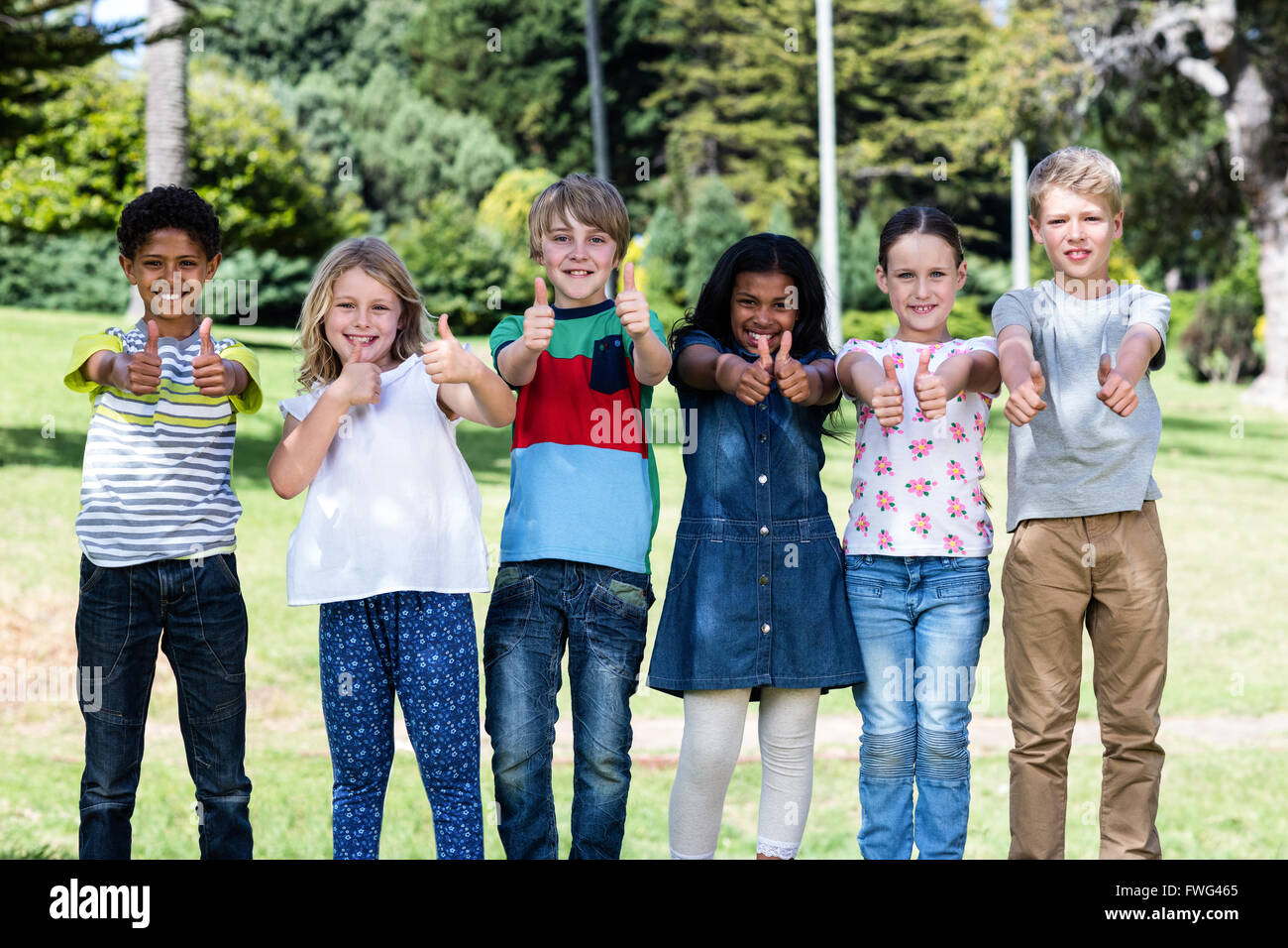 Portrait of happy children standing together in park Stock Photo - Alamy