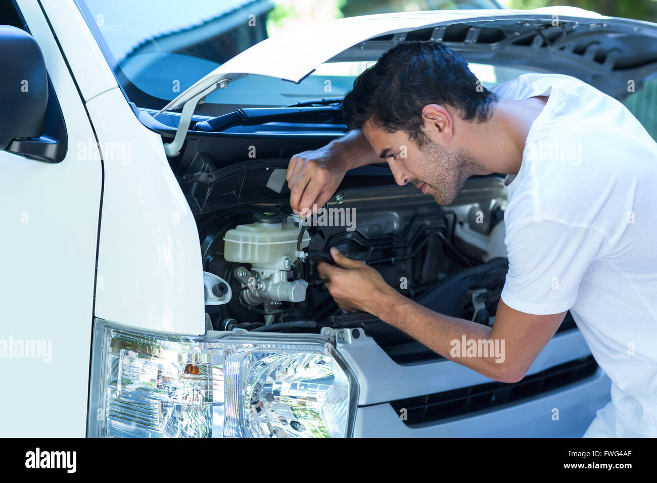 Side view of mechanic repairing van Stock Photo - Alamy