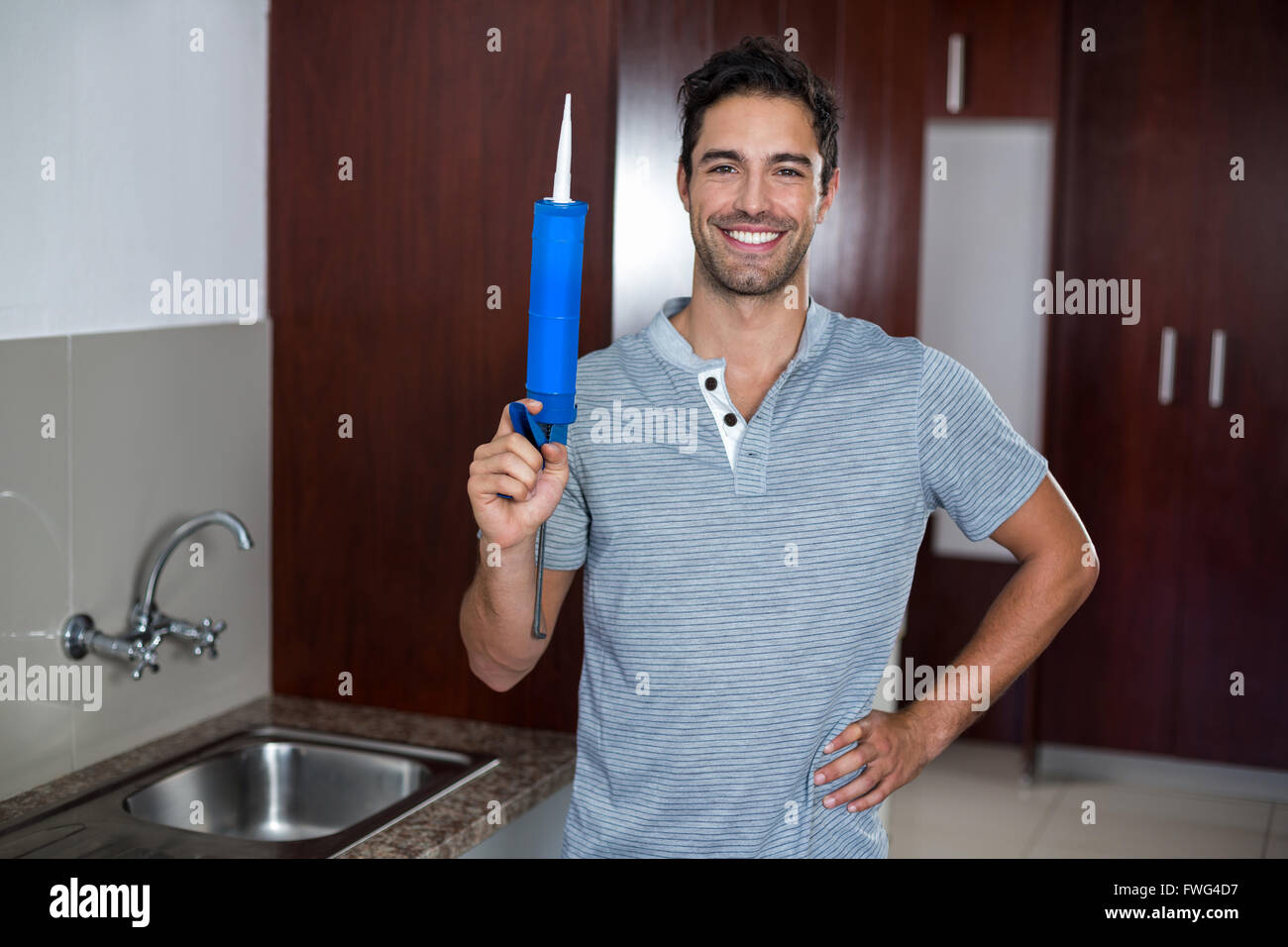Man with hand on hip while holding pest control injection Stock Photo ...