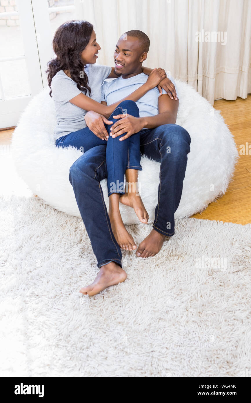Young couple relaxing on the bean bag Stock Photo - Alamy