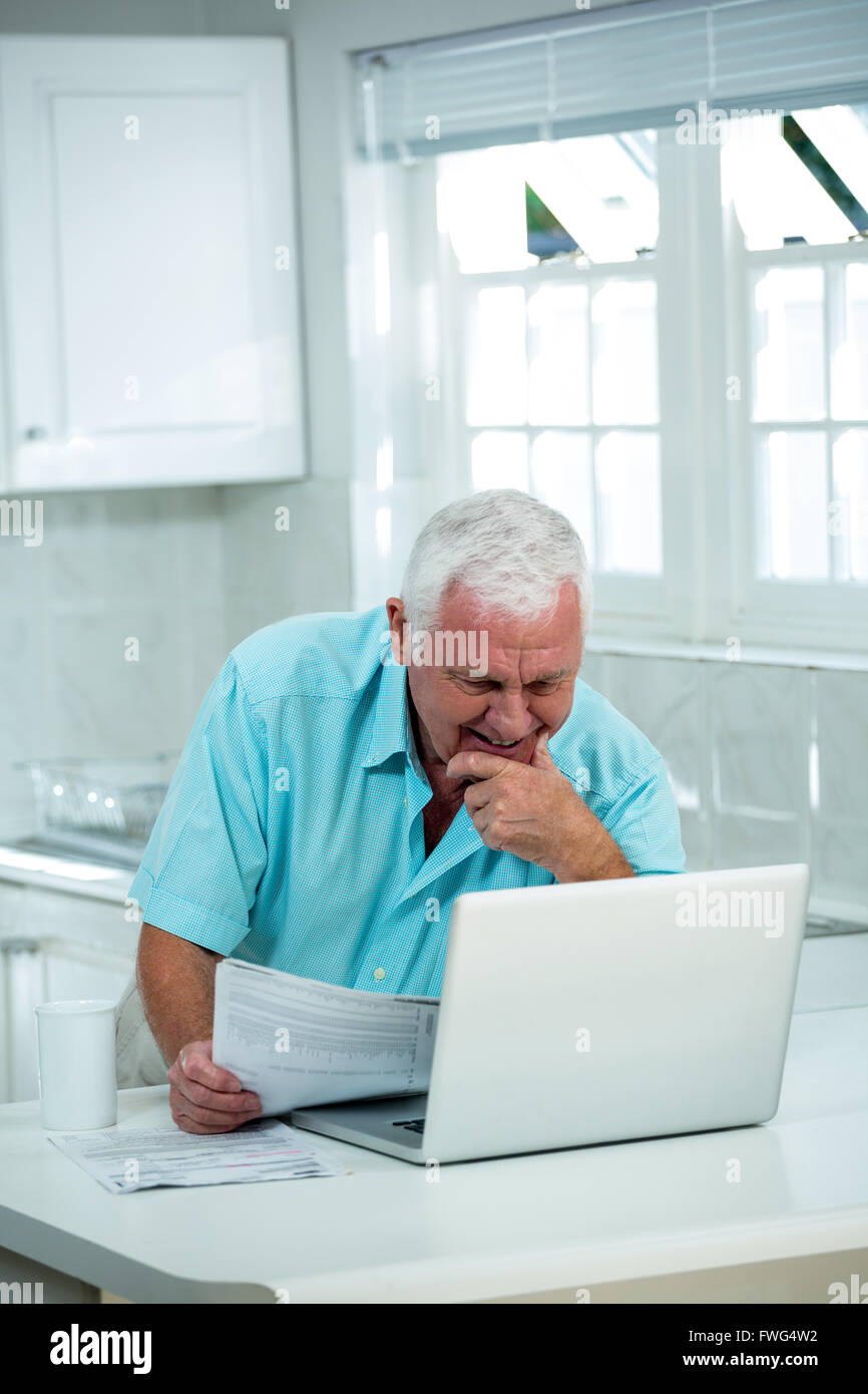Smiling man looking into laptop Stock Photo - Alamy