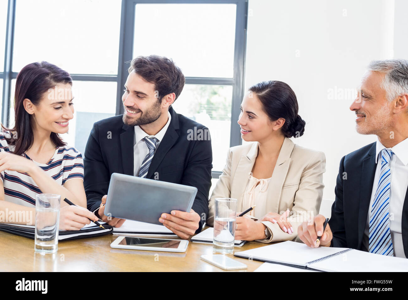 Workers are smiling and looking each other Stock Photo - Alamy