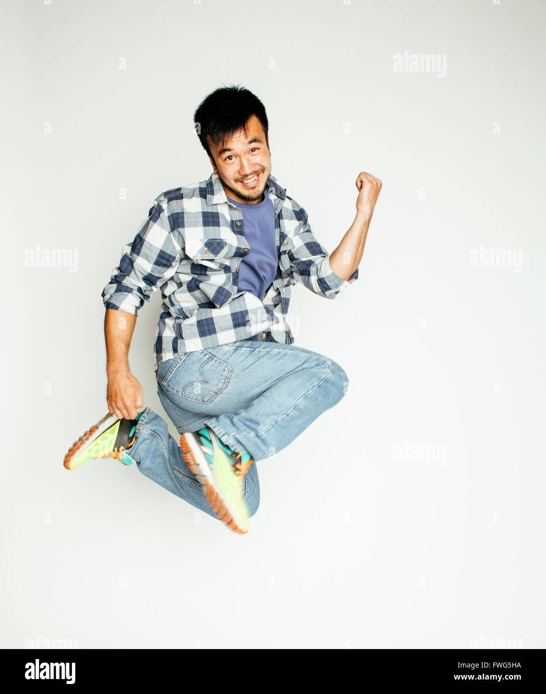 young pretty asian man jumping cheerful against white background ...