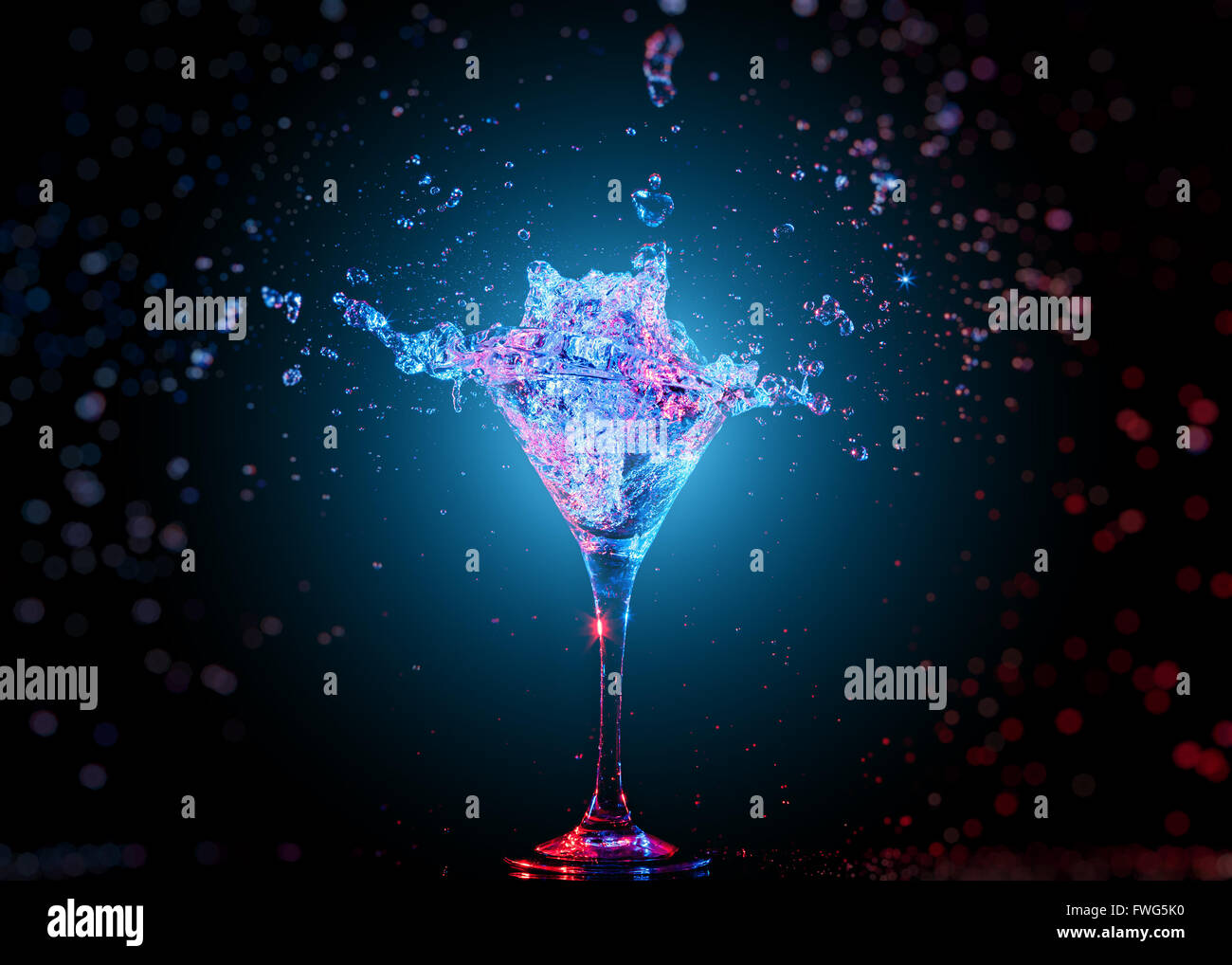 Colourful cocktail in glass with splash Stock Photo - Alamy