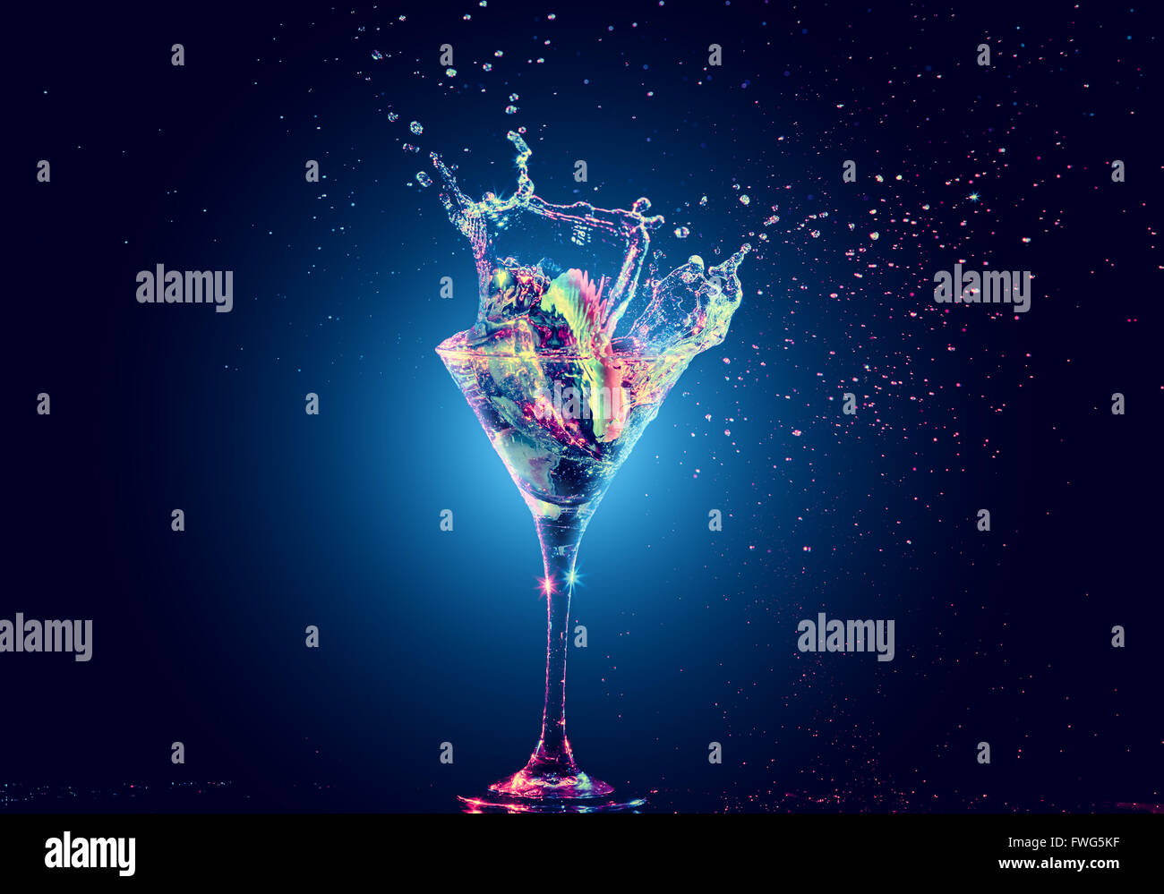 Colourful cocktail in glass with splash Stock Photo - Alamy