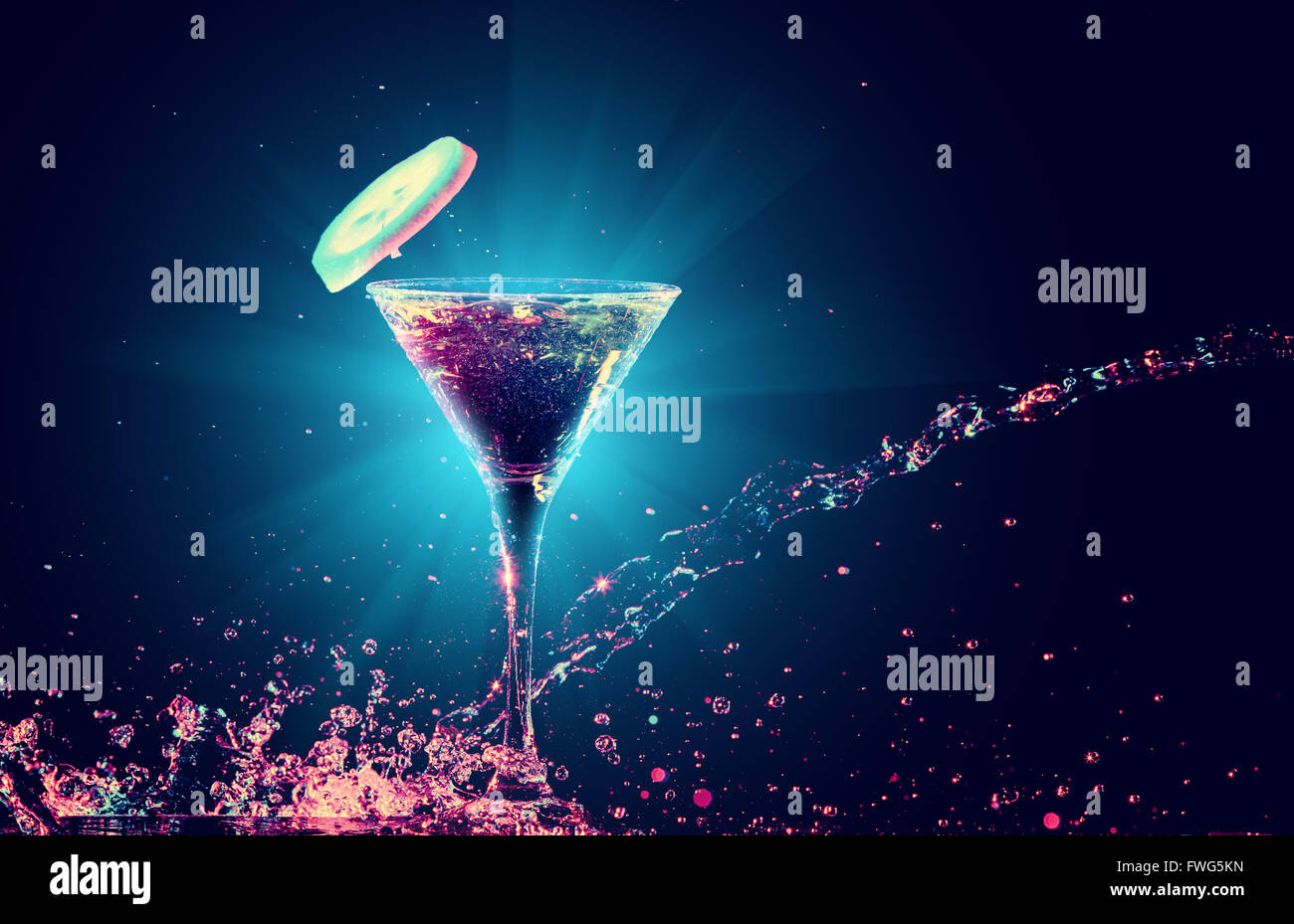 Colourful cocktail in glass with splash Stock Photo - Alamy