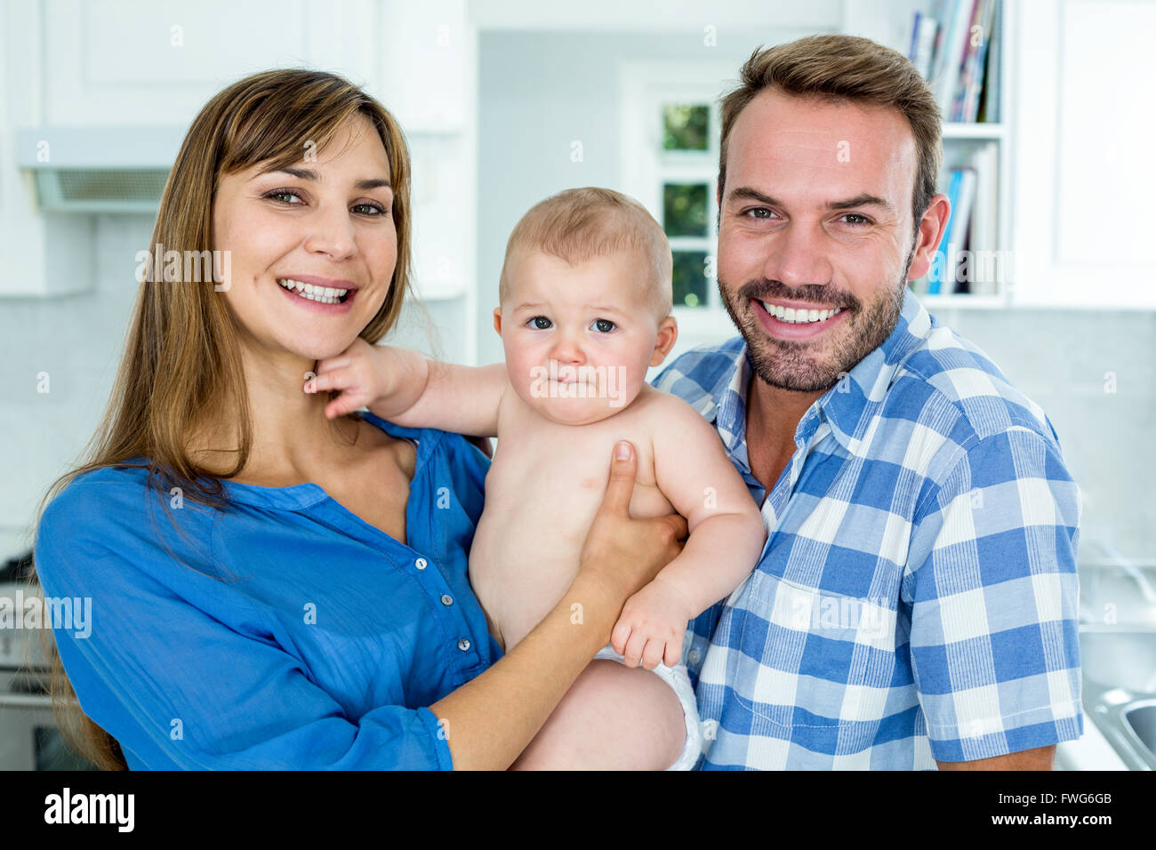 Happy parents with baby boy at home Stock Photo - Alamy