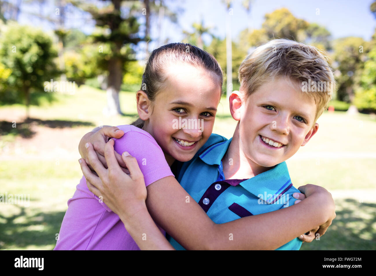 Siblings embracing each other Stock Photo - Alamy