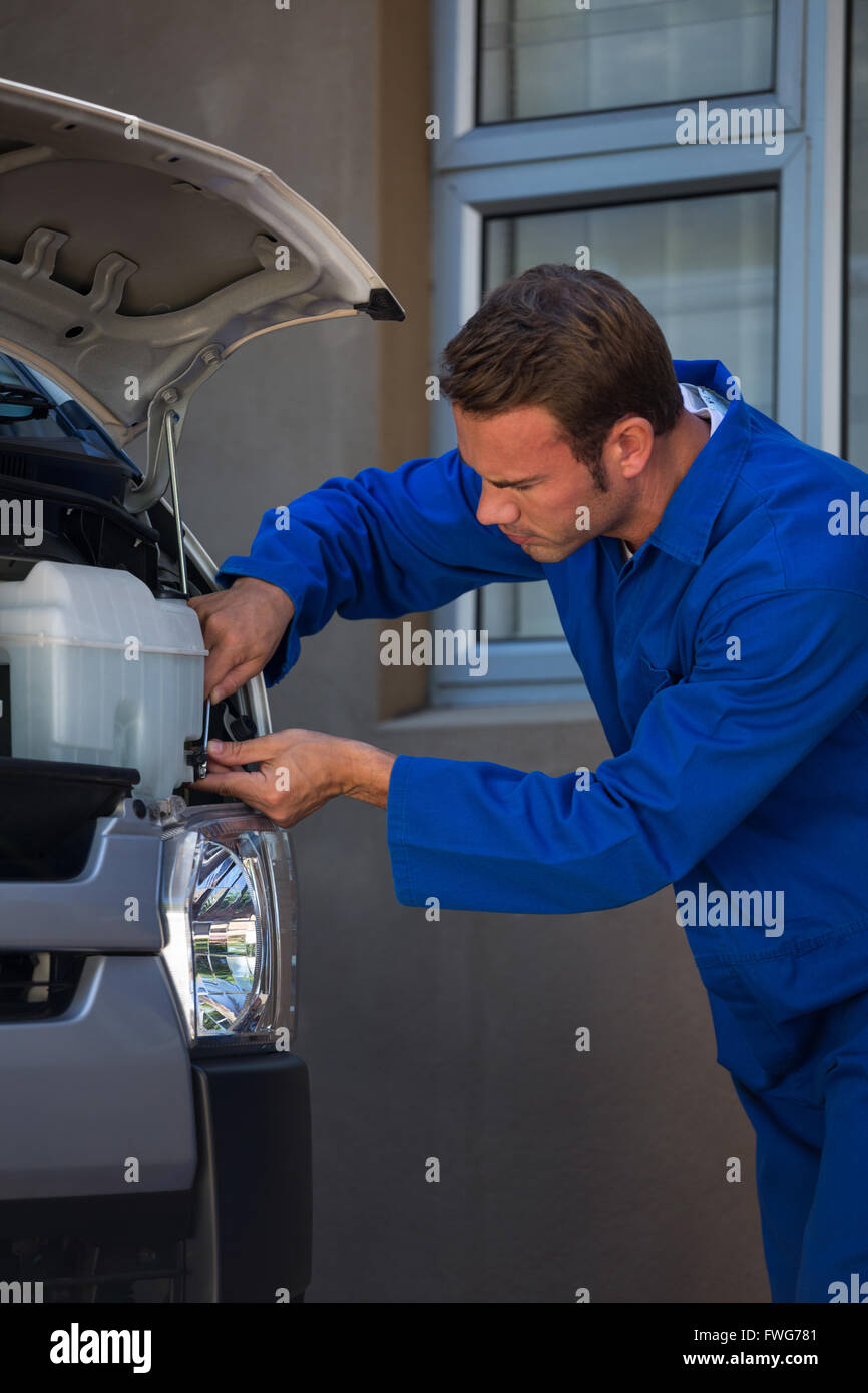 Mechanic examining the car Stock Photo - Alamy