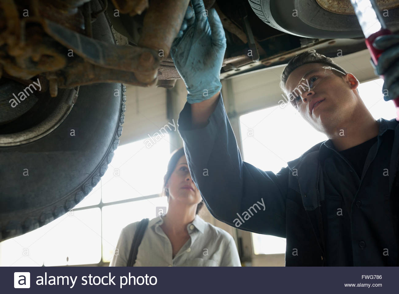 Customer standing with mechanic by car hi-res stock photography and ...