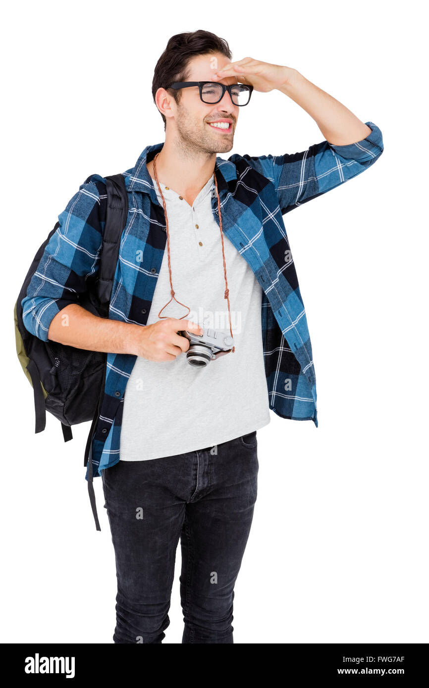 Young man carrying rucksack and holding camera Stock Photo - Alamy