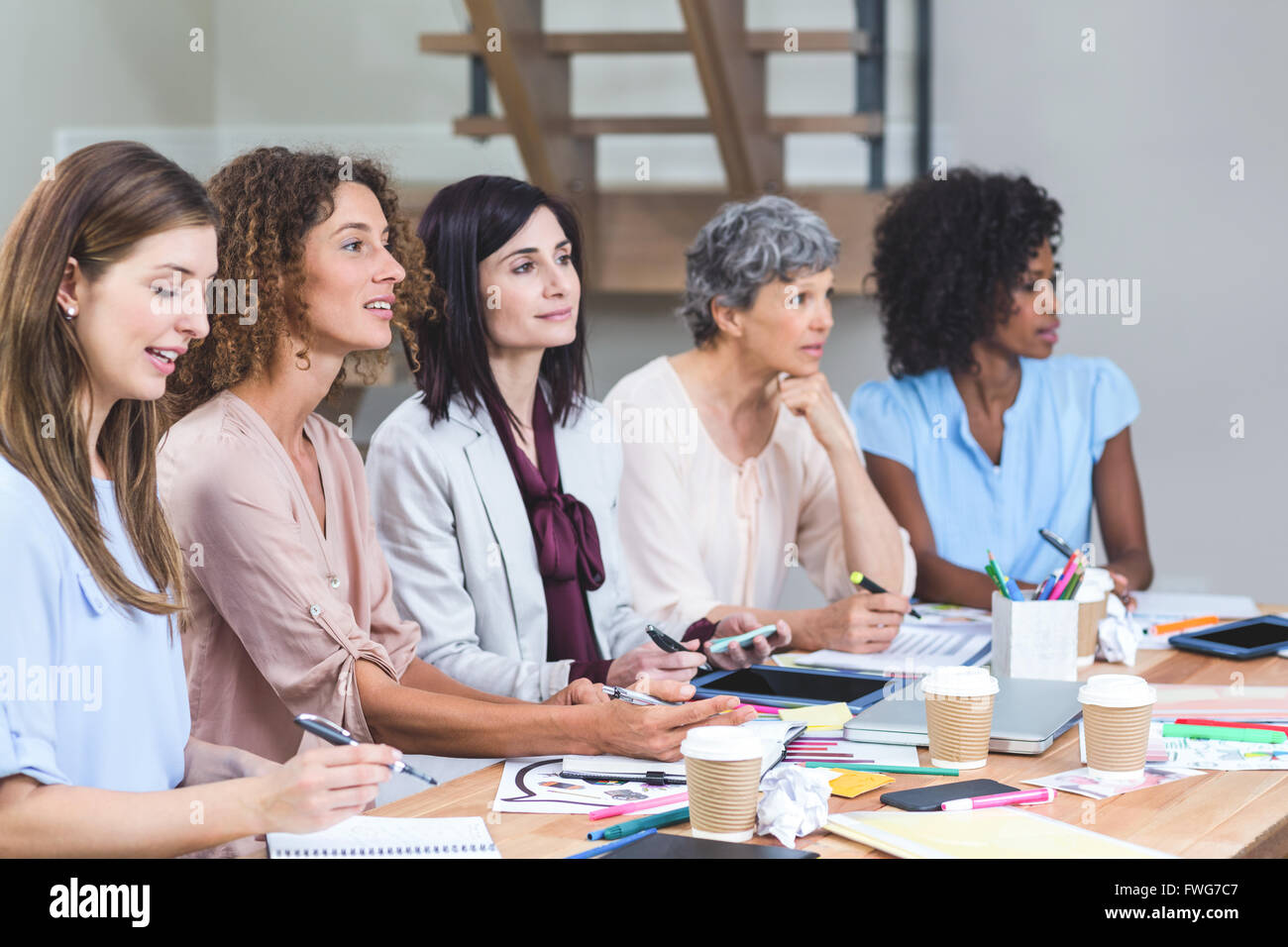 Group of interior designers listening to presentation Stock Photo - Alamy