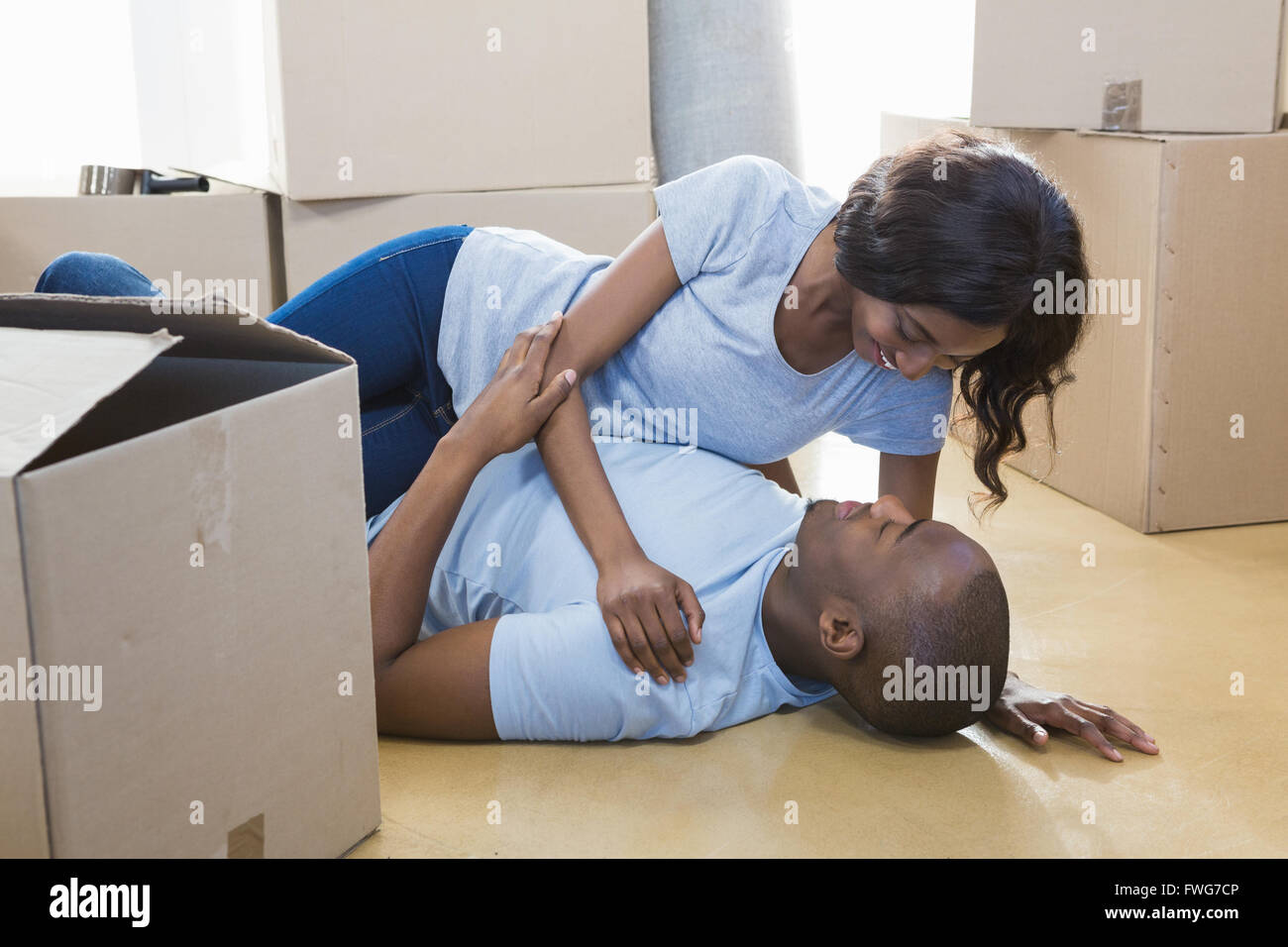 Young couple cuddling in their new house Stock Photo - Alamy