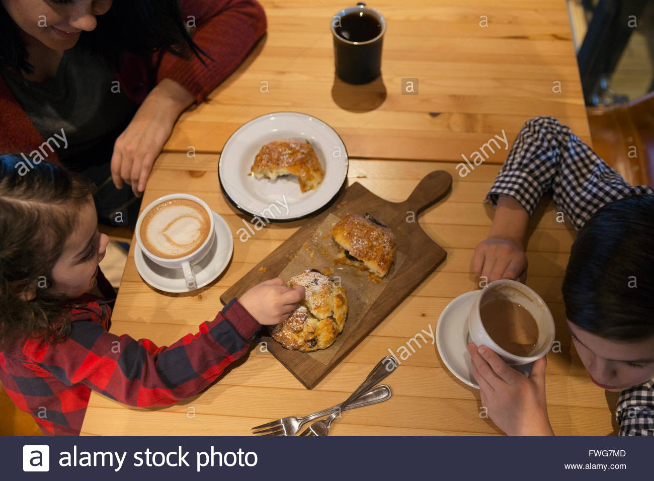 Family enjoying coffee and pastries in bakery Stock Photo - Alamy