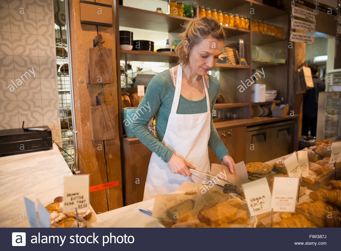 Working behind counter hi-res stock photography and images - Alamy
