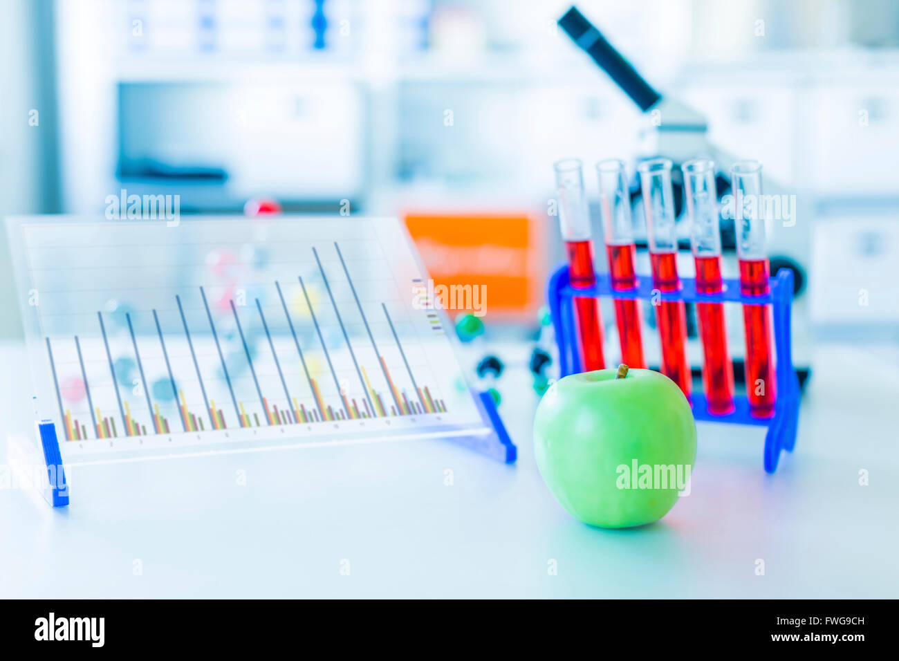 Apple and test tubes in a laboratory Stock Photo - Alamy