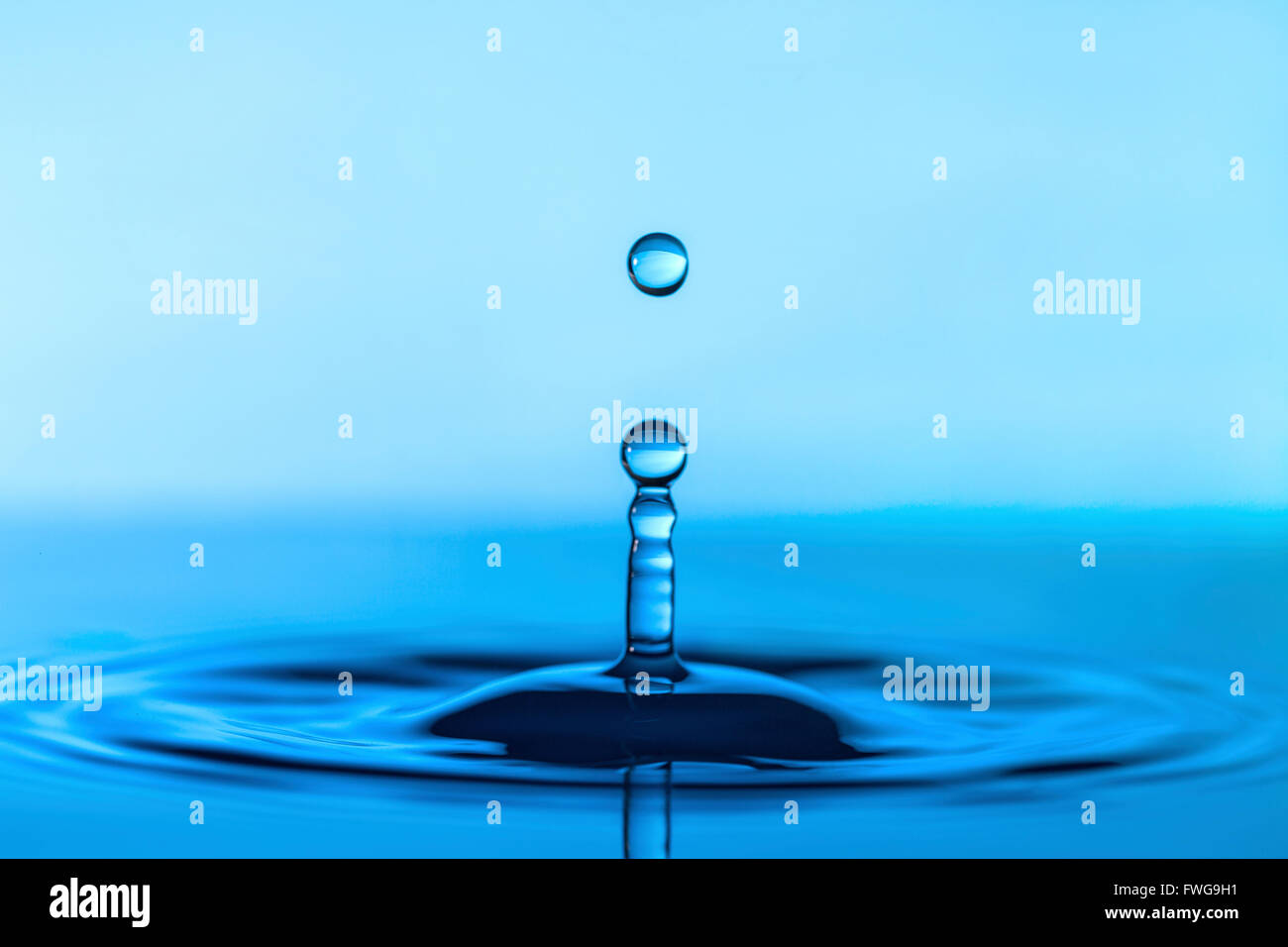 Water droplet falling on water surface Stock Photo - Alamy