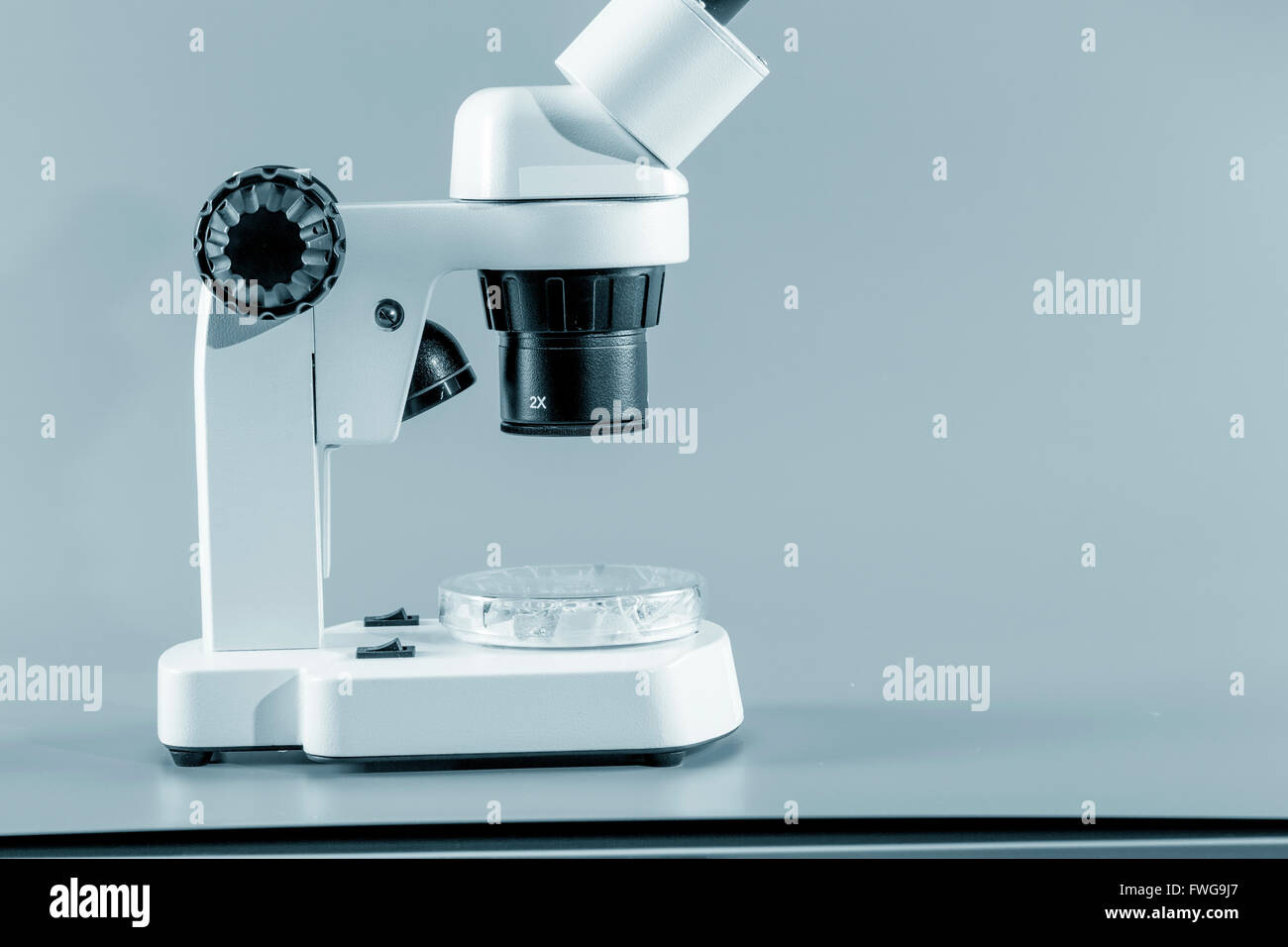 Monocular microscope against a grey background Stock Photo - Alamy