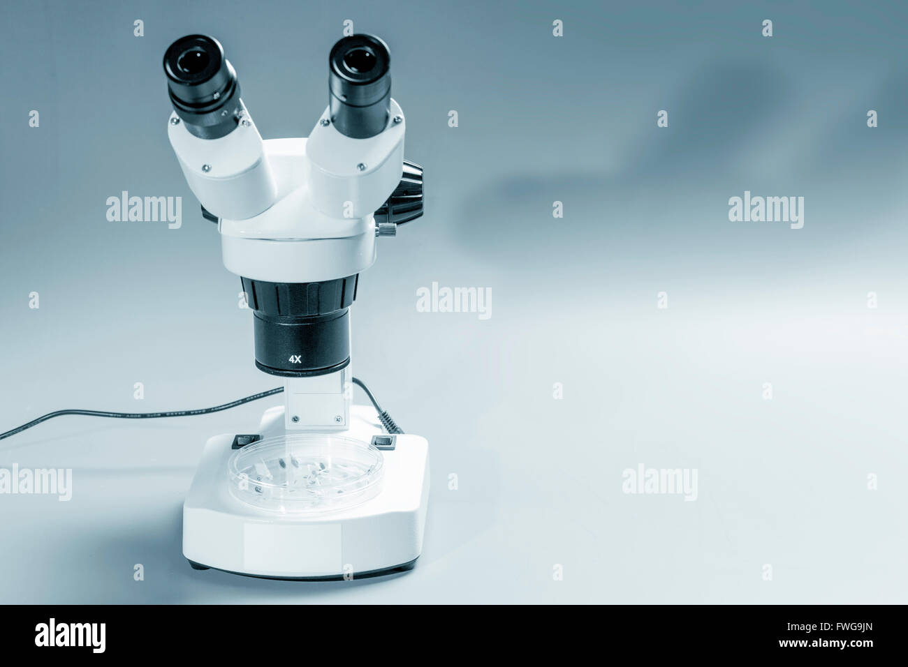 Medical microscope against a grey background Stock Photo - Alamy