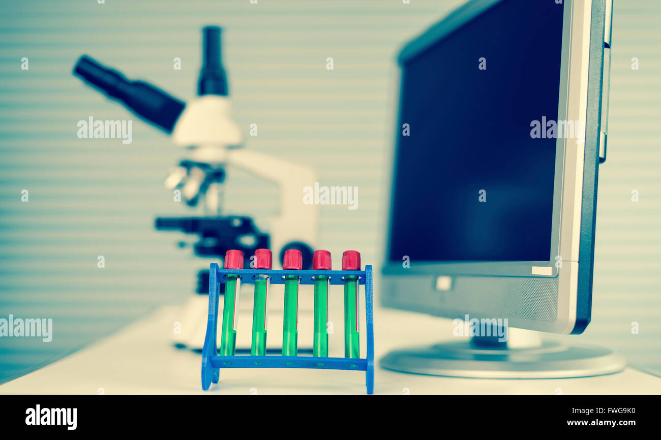 Test tubes and computer monitor in the laboratory Stock Photo - Alamy