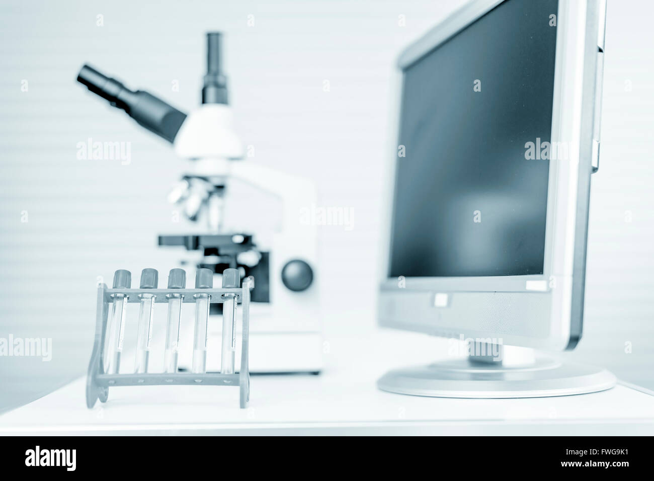 Test tubes and computer monitor in the laboratory Stock Photo - Alamy