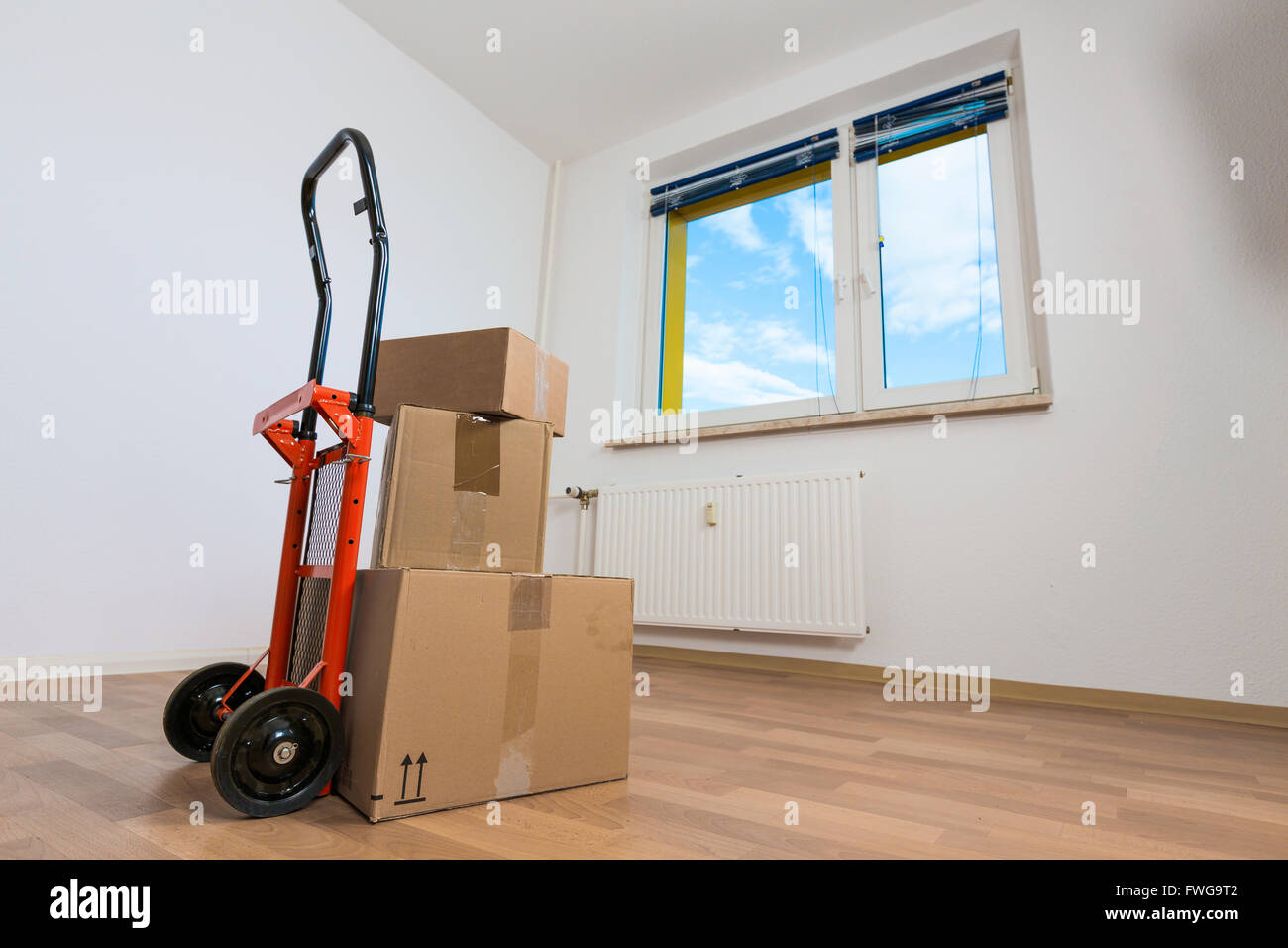 Cardboard boxes on a trolley in an empty room Stock Photo - Alamy