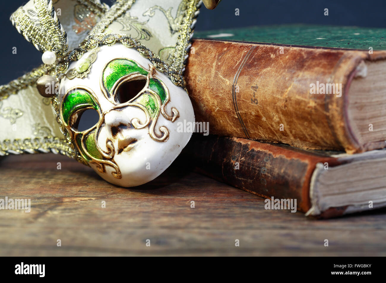 Art concept. Vintage still life with old books near Venetian mask Stock ...