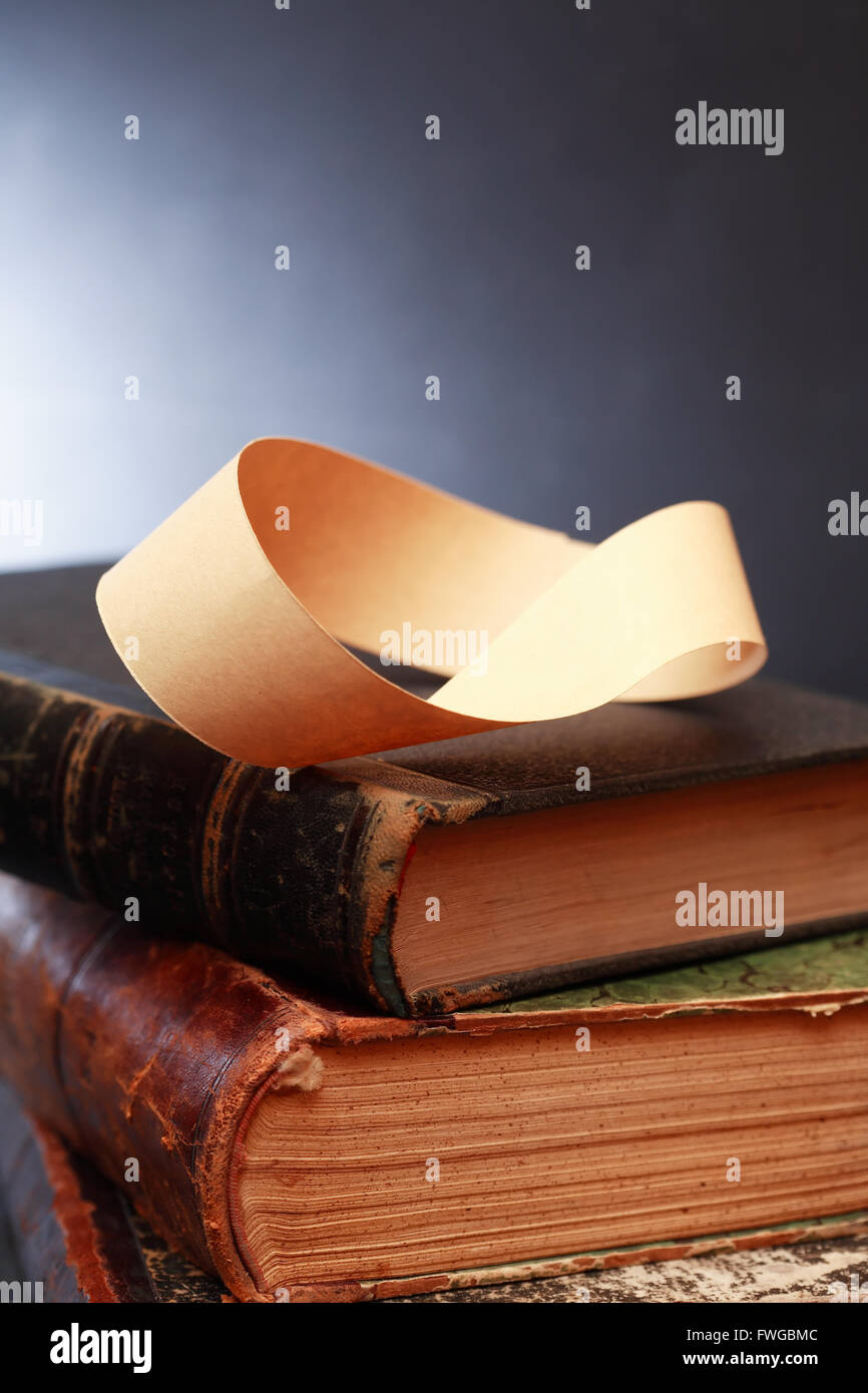 Paper Mobius strip on old books against dark background Stock Photo - Alamy