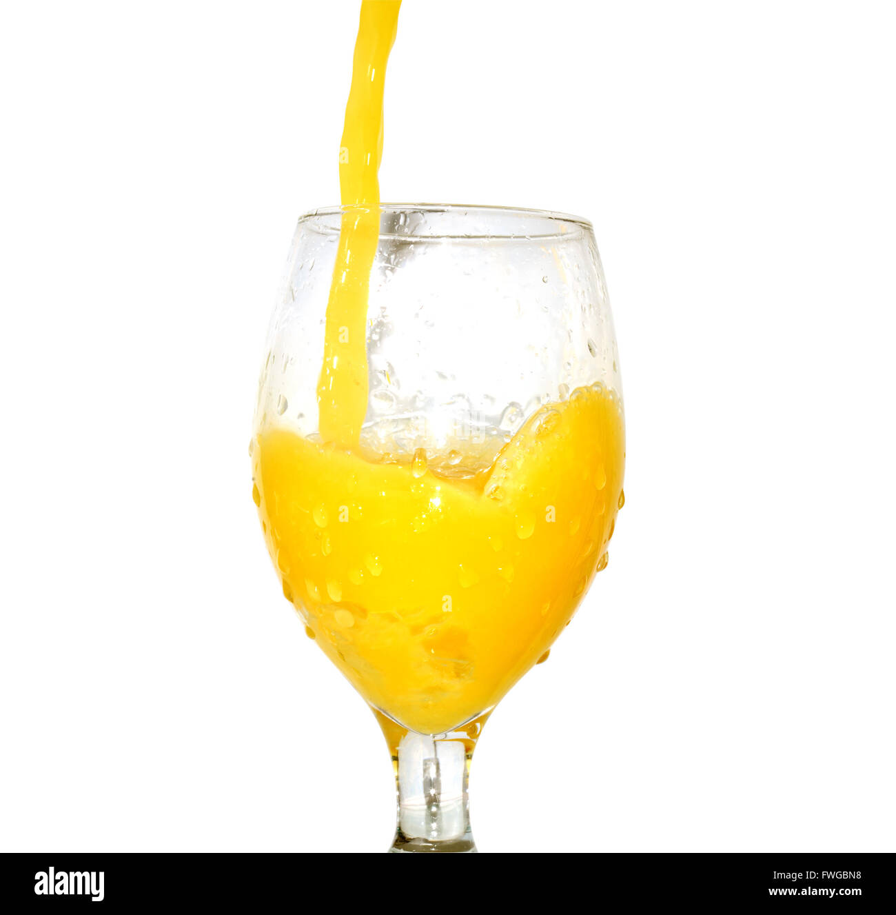 Orange juice flowing to glass on white background. Clipping path is ...