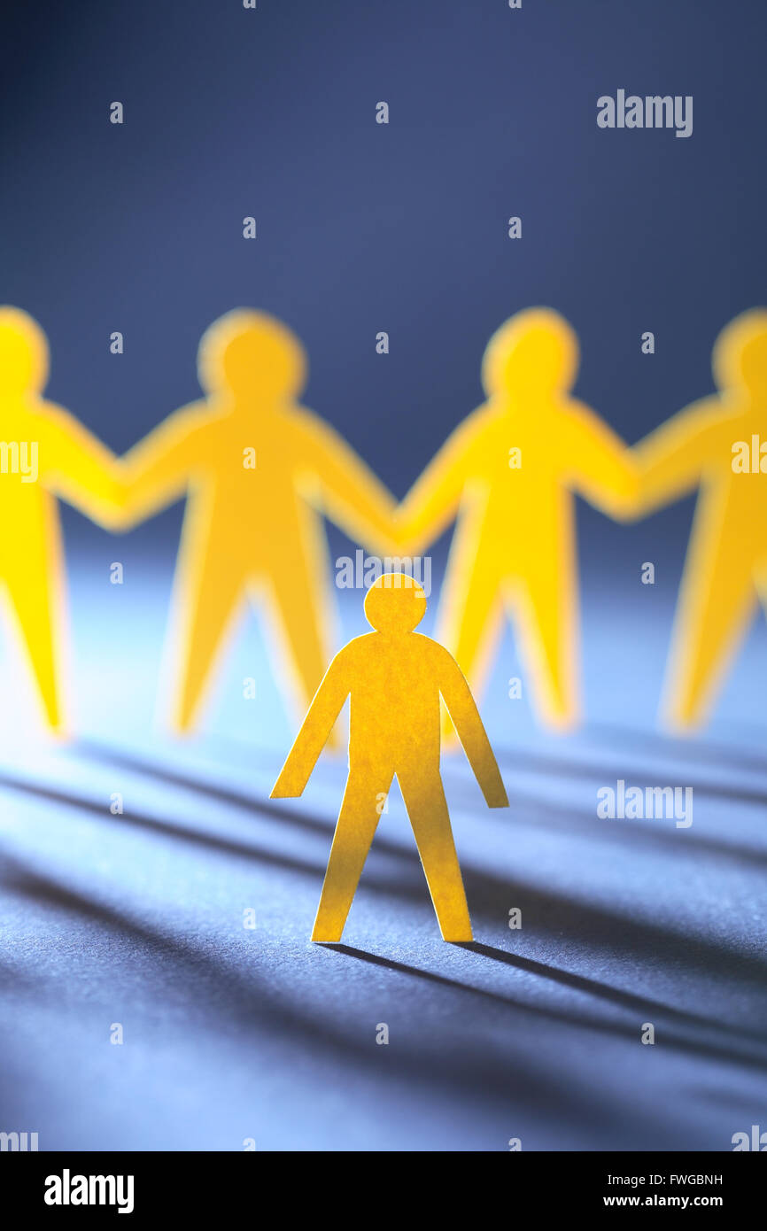 Robbery concept. Yellow paper man against crowd in a row on dark Stock ...