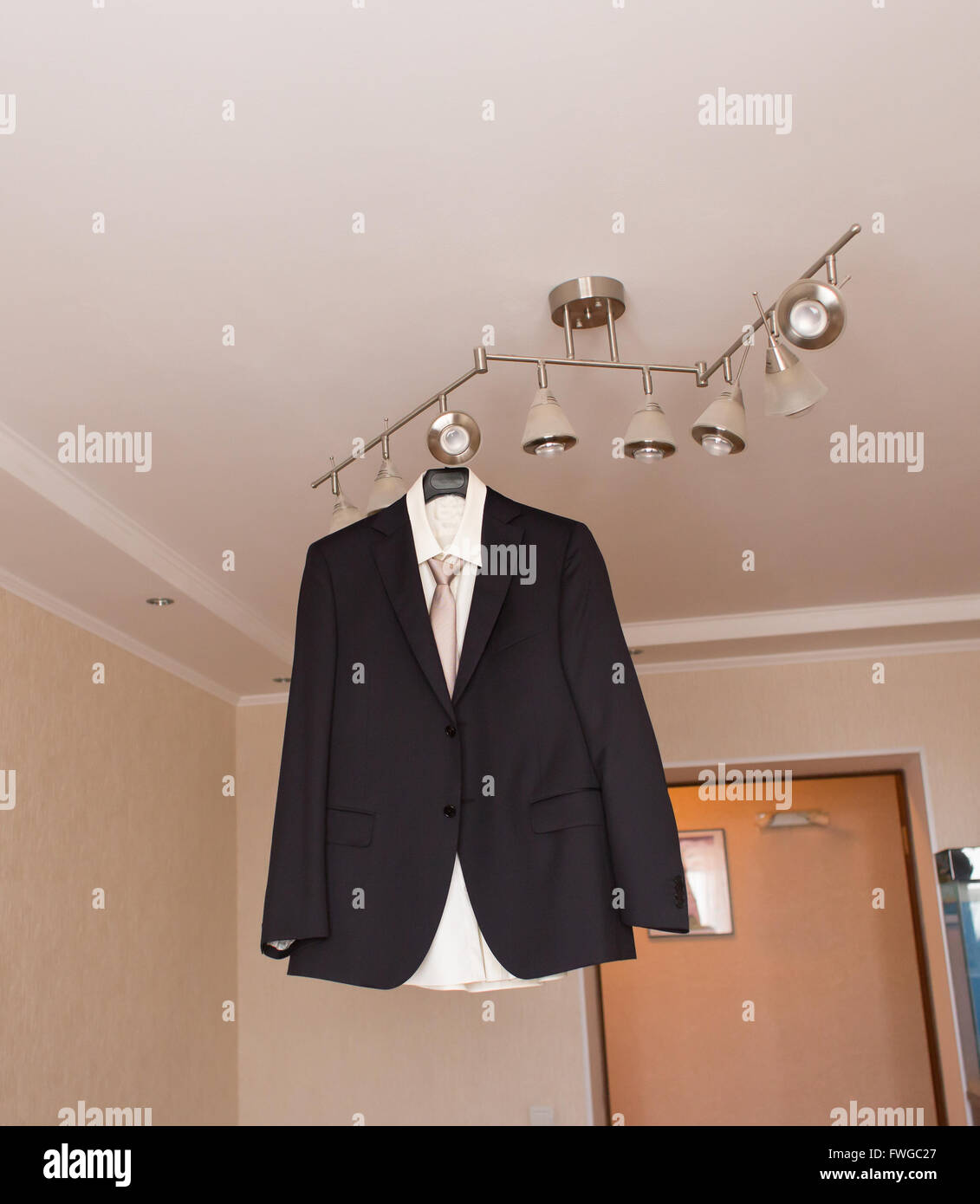 suit hanging on hangers Stock Photo - Alamy
